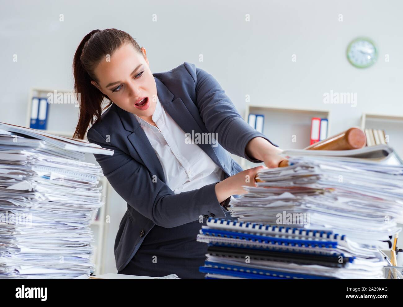 The angry businesswoman with baseball bat in office Stock Photo - Alamy