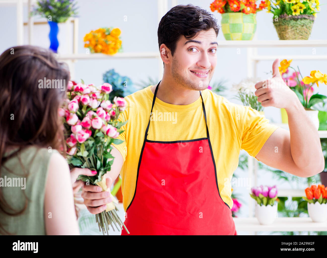 The florist selling flowers in a flower shop Stock Photo - Alamy