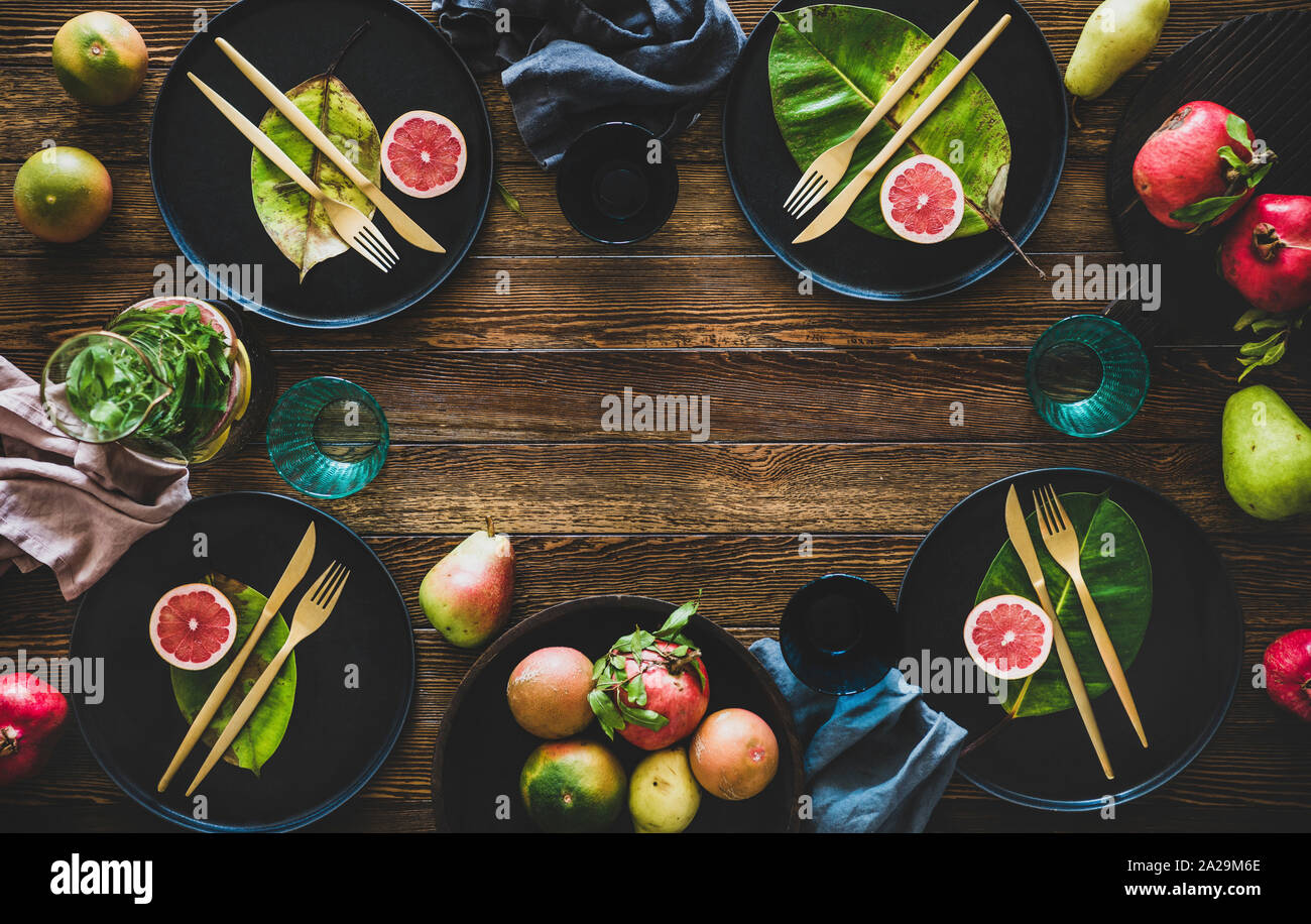 Autumn table styling for holiday dinner. Flat-lay of black dinnerware ...