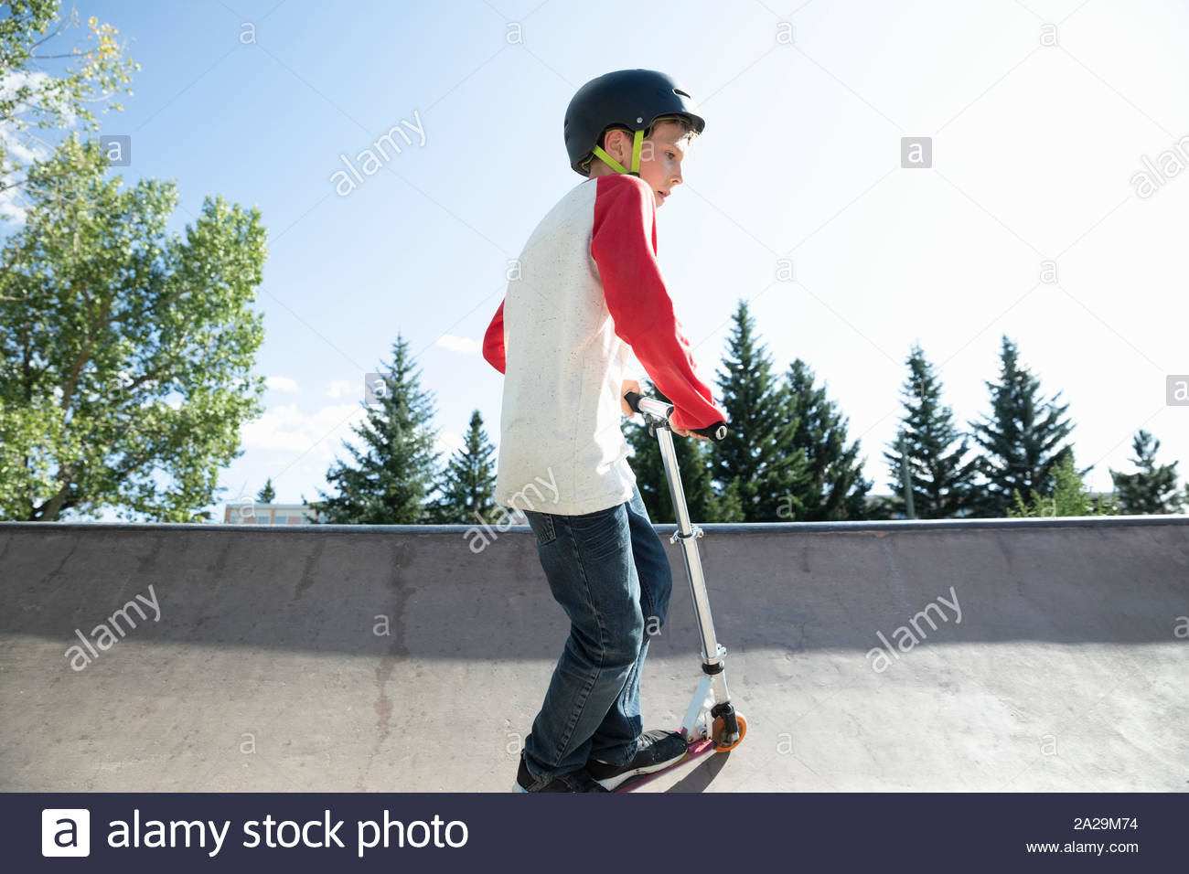 Boy riding scooter hi-res stock photography and images - Alamy