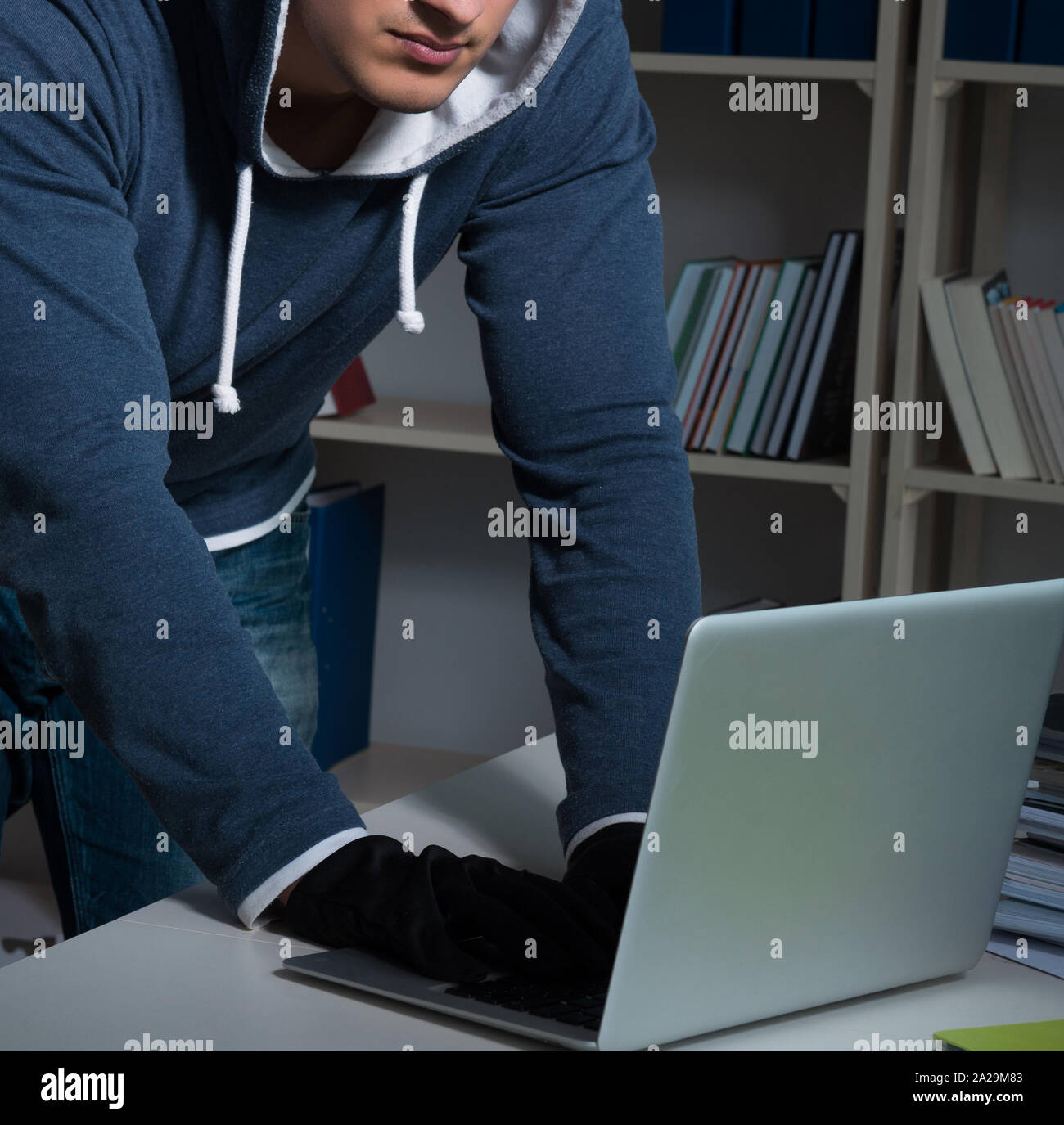 The young hacker hacking into computer at night Stock Photo - Alamy