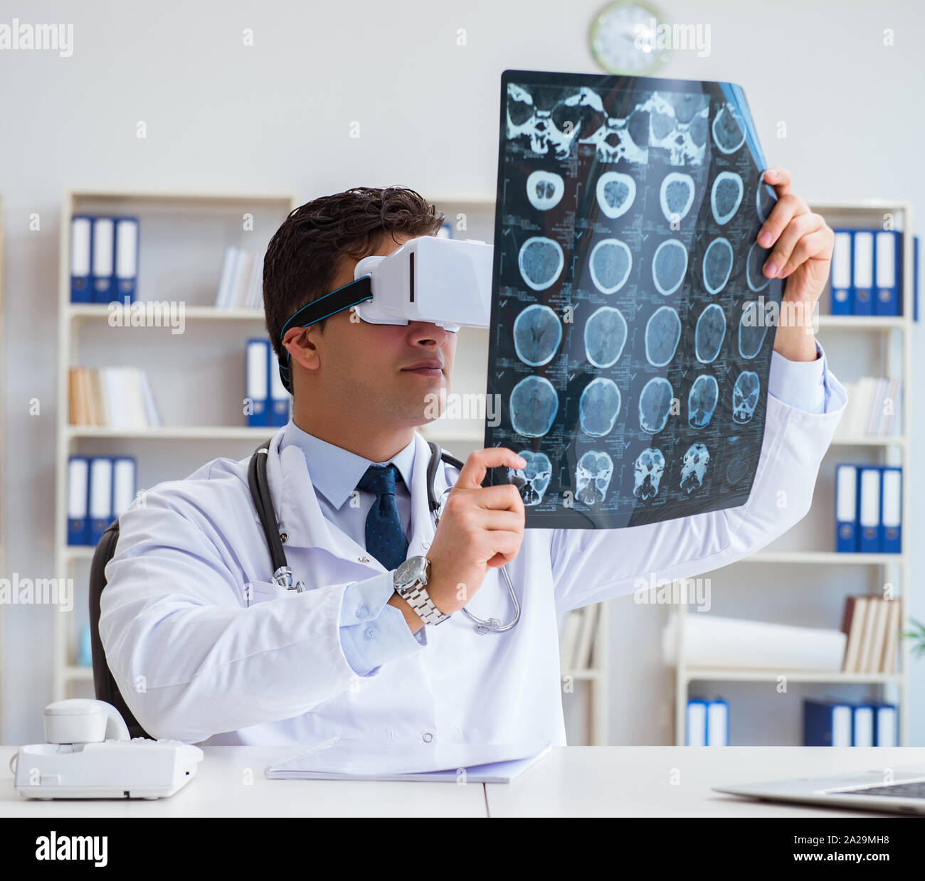 The young doctor looking at mri scan through vr glasses Stock Photo - Alamy