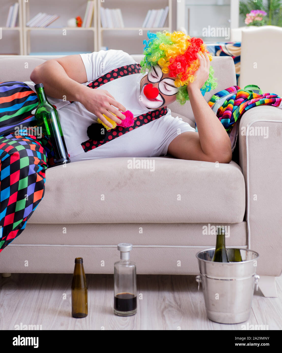 The drunk clown celebrating having a party at home Stock Photo - Alamy