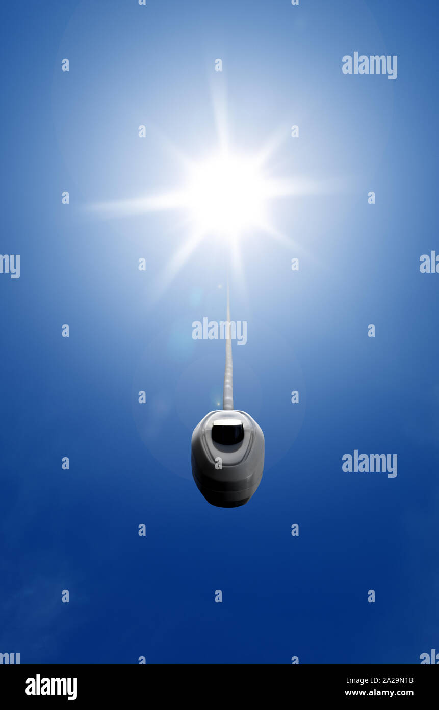 Lamp switch connected to the sun in blue sky, illustrating renewable ...