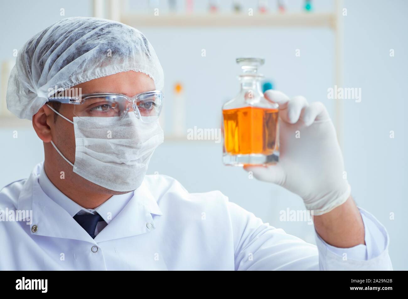The chemist mixing perfumes in the lab Stock Photo - Alamy