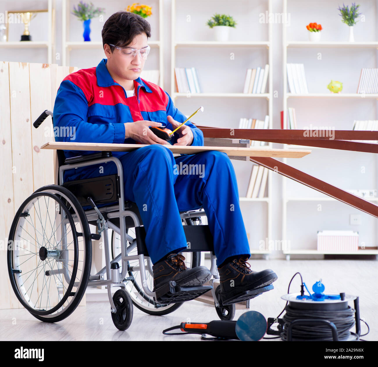 The disabled carpenter taking measurement in workshop Stock Photo - Alamy