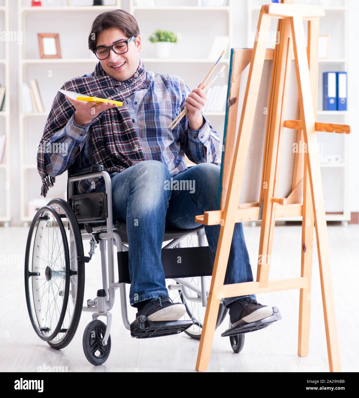 The disabled artist painting picture in studio Stock Photo - Alamy