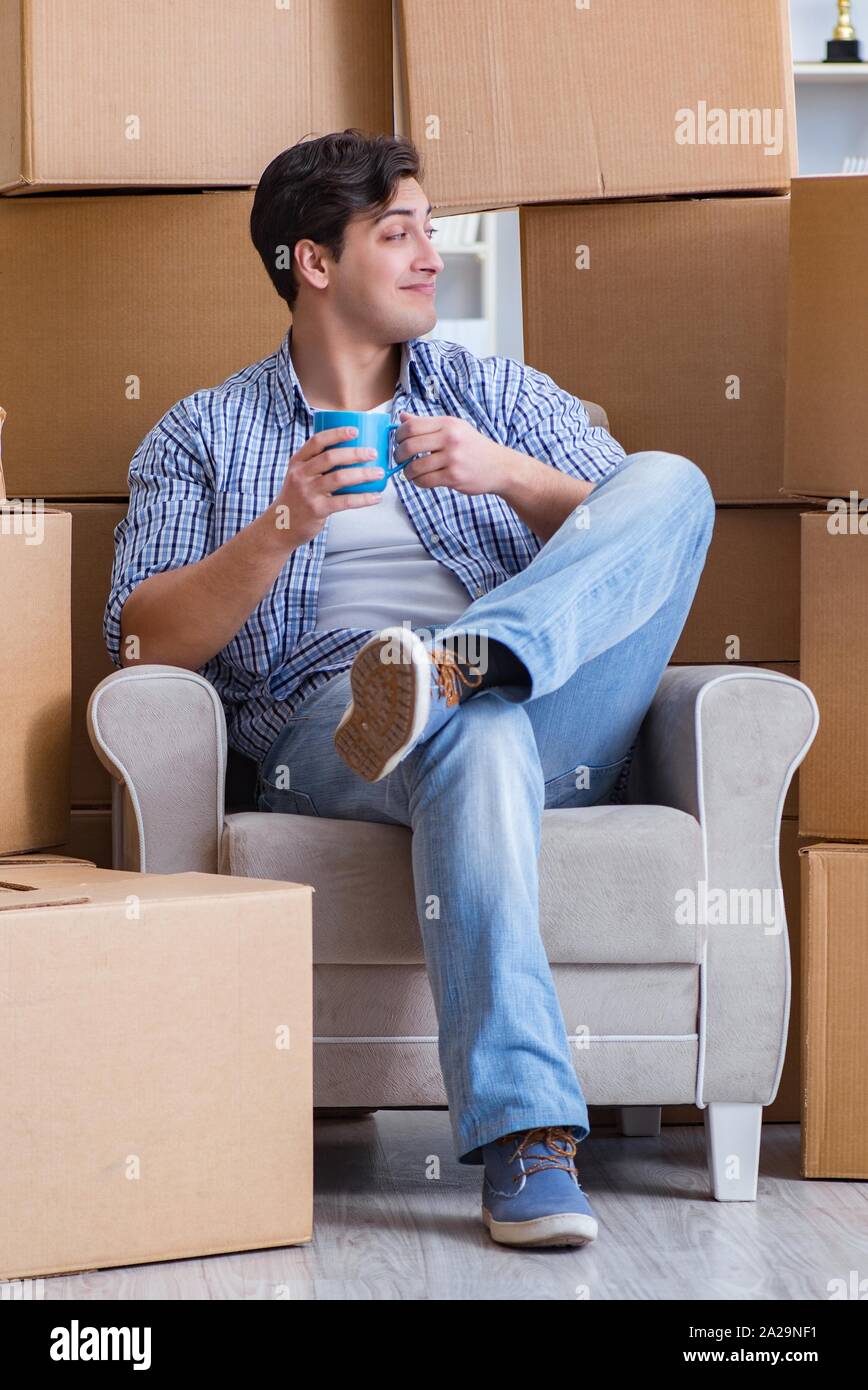 The young man moving in to new house with boxes Stock Photo - Alamy