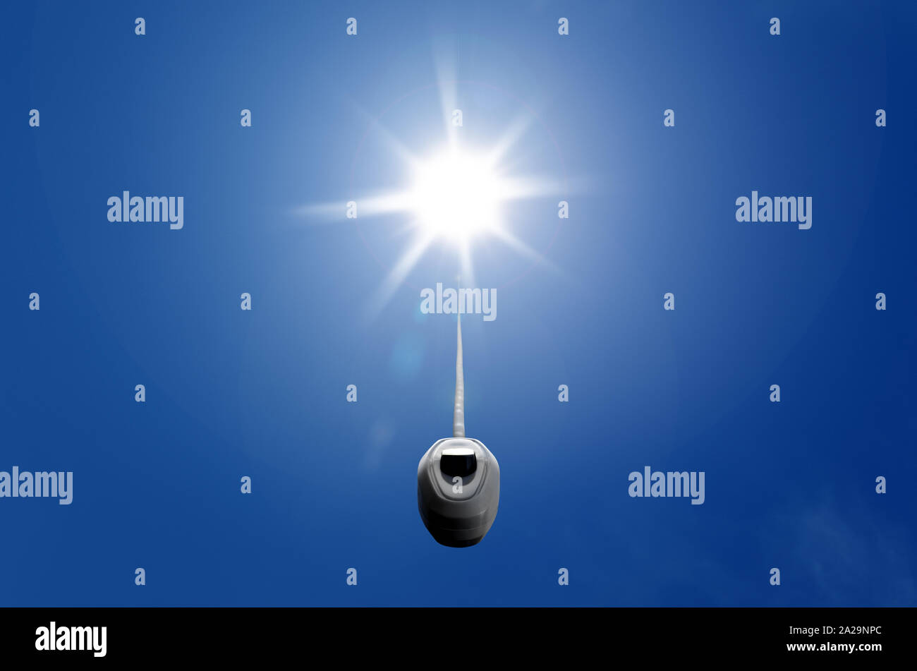 Lamp switch connected to the sun in blue sky, illustrating renewable ...