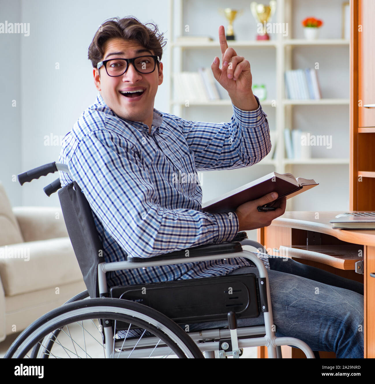 The disabled student studying at home on wheelchair Stock Photo - Alamy