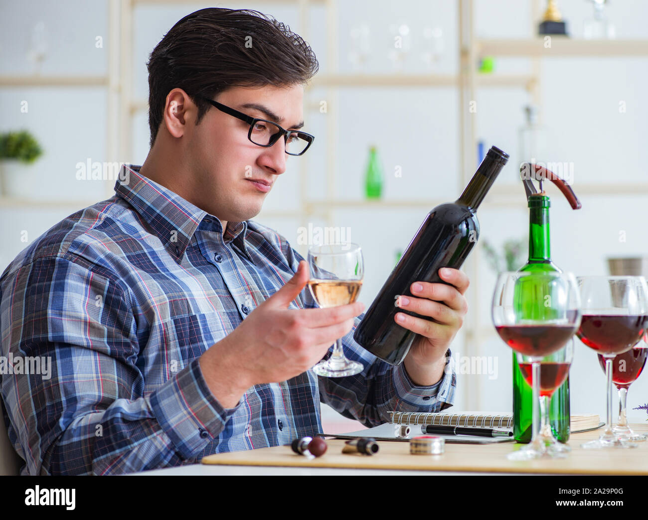 The professional sommelier tasting red wine Stock Photo - Alamy