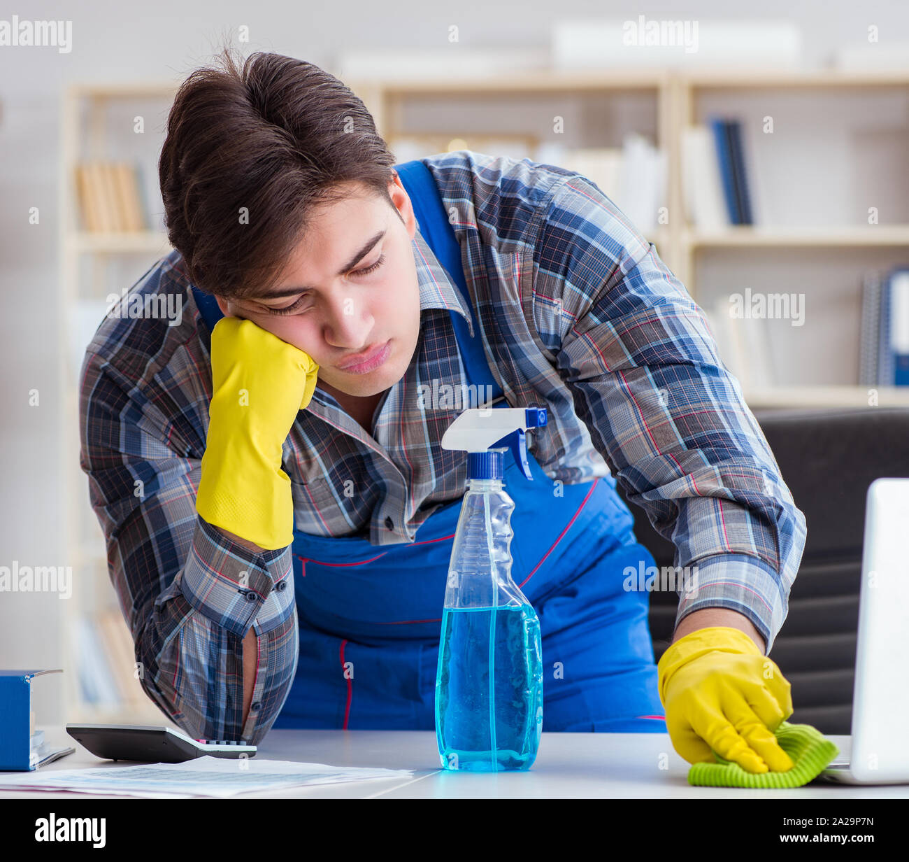 The male cleaner working in the office Stock Photo - Alamy