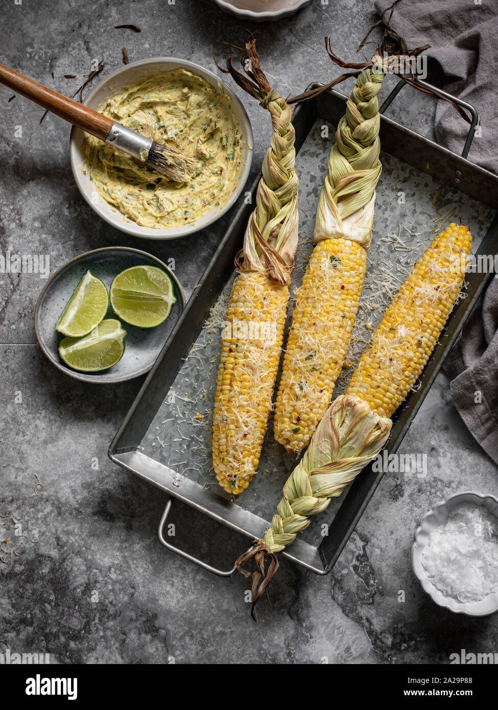 Mexican street corn on the cob. Ingredients off to the side: herbed ...