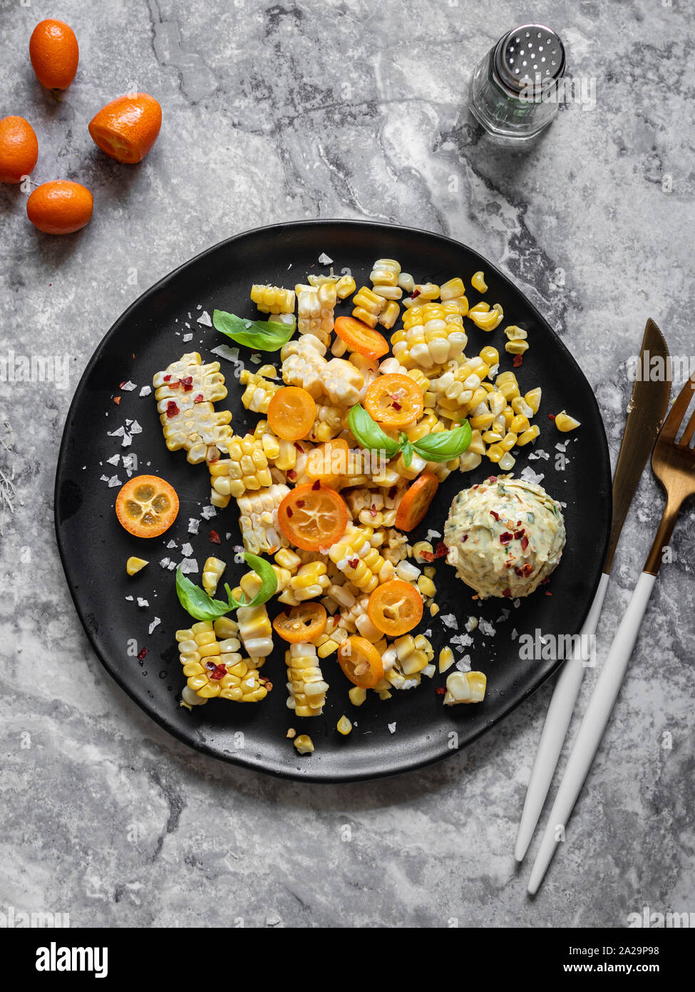 Shaved mexican street corn with herbed butter scoop on the plate Stock ...