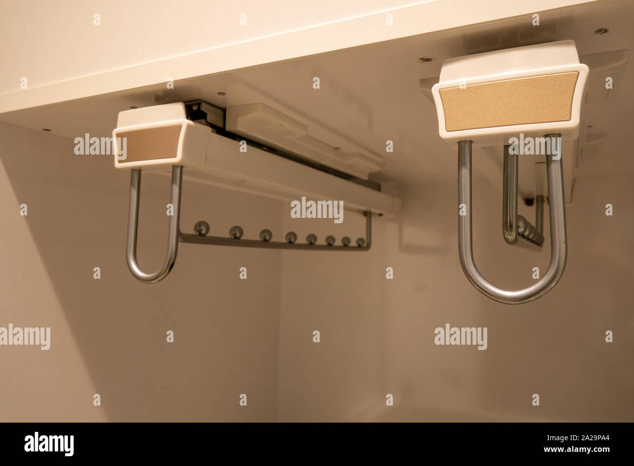 Retractable hanger for trousers and ties inside the wardrobe Stock ...