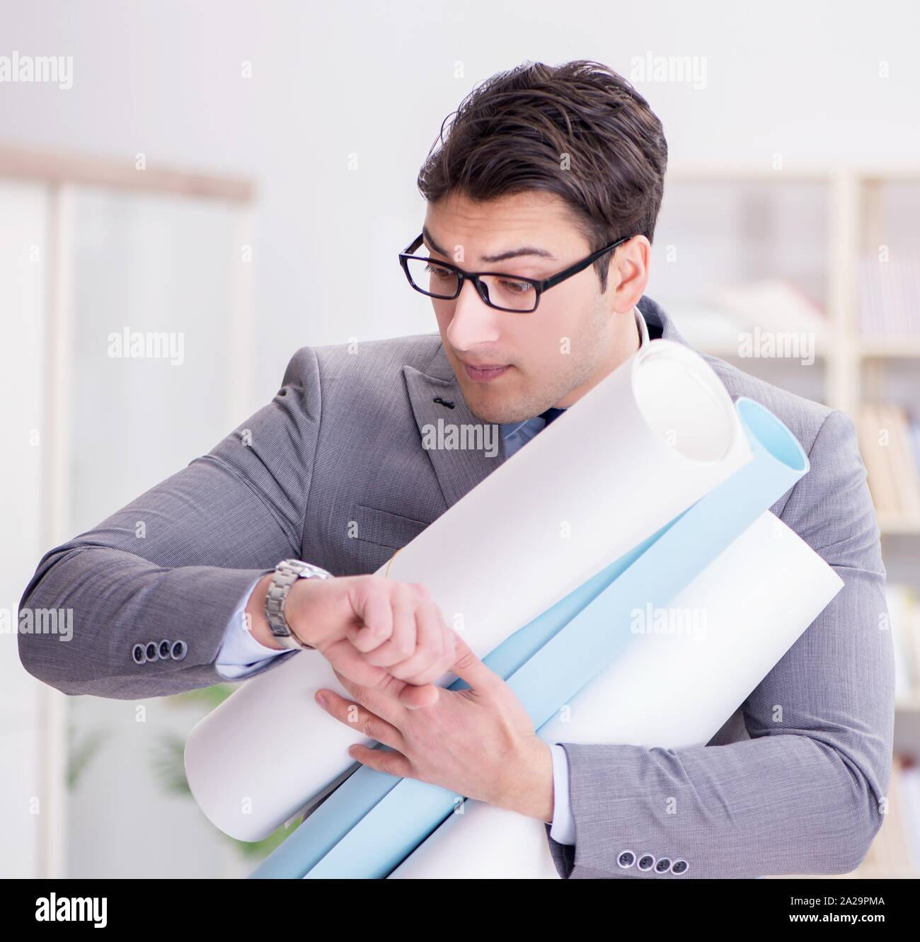 The businessman engineer draftsman with blueprints drawings Stock Photo ...