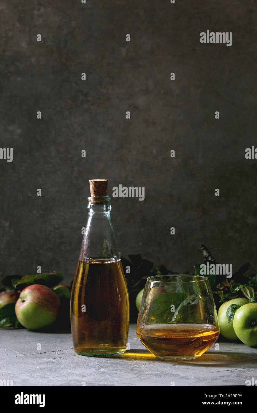 Bottle ang glass of apple juice with garden apples with leaves and ...