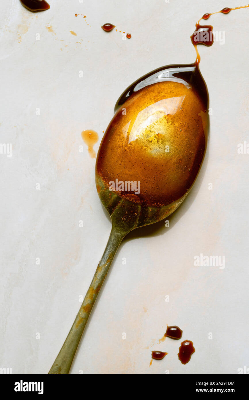 A spoon coated with rich golden syrup Stock Photo - Alamy