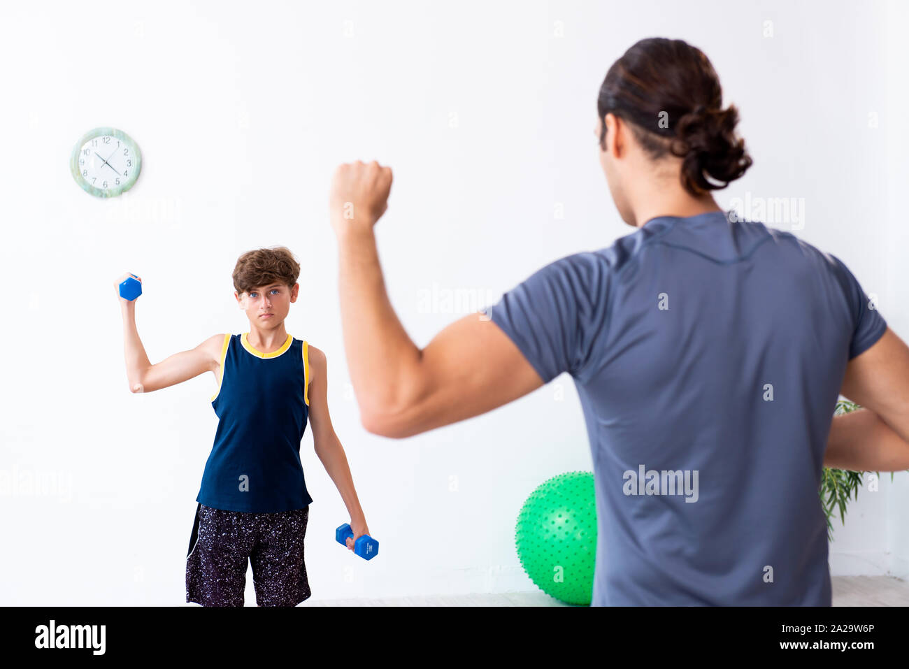The young father and his son doing exercises Stock Photo - Alamy