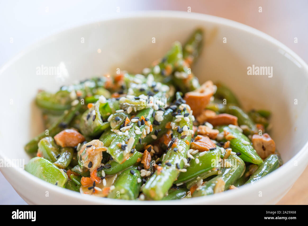 Vegetarian food. Charred green beans, ginger, crispy cashews Stock ...