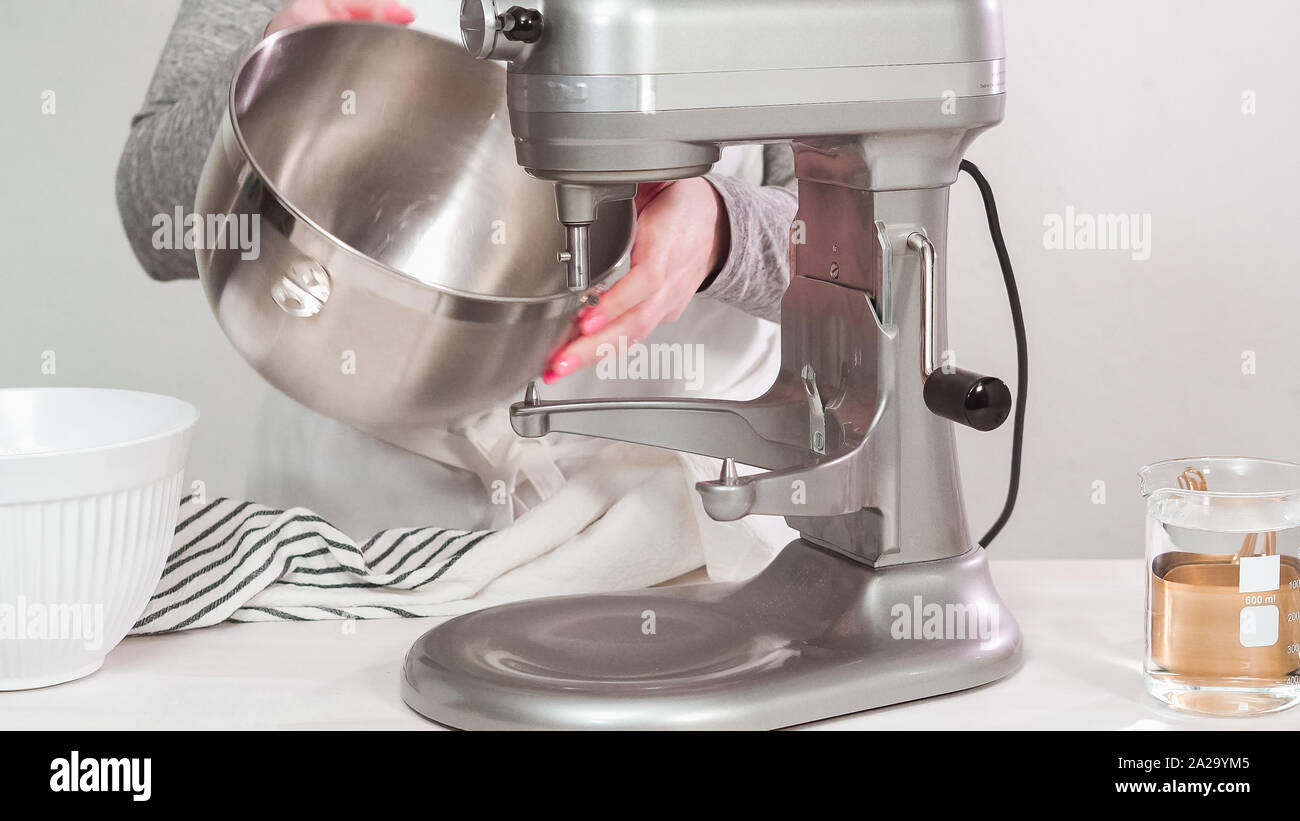 Step by step. Flat lay. Mixing royal icing in electric kitchen mixer ...