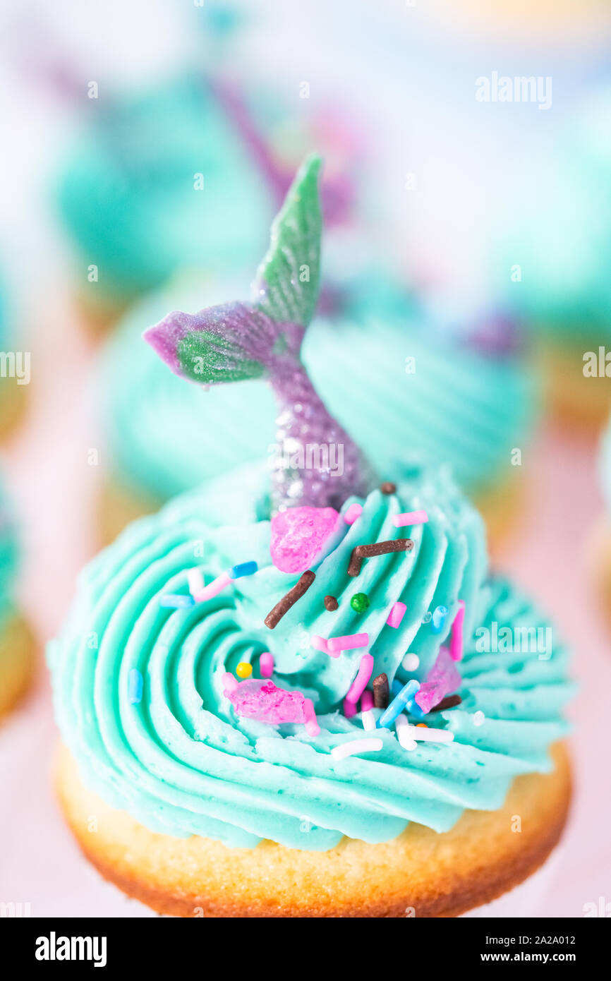 Gourmet mermaid cupcakes topped with blue buttercream frosting and ...