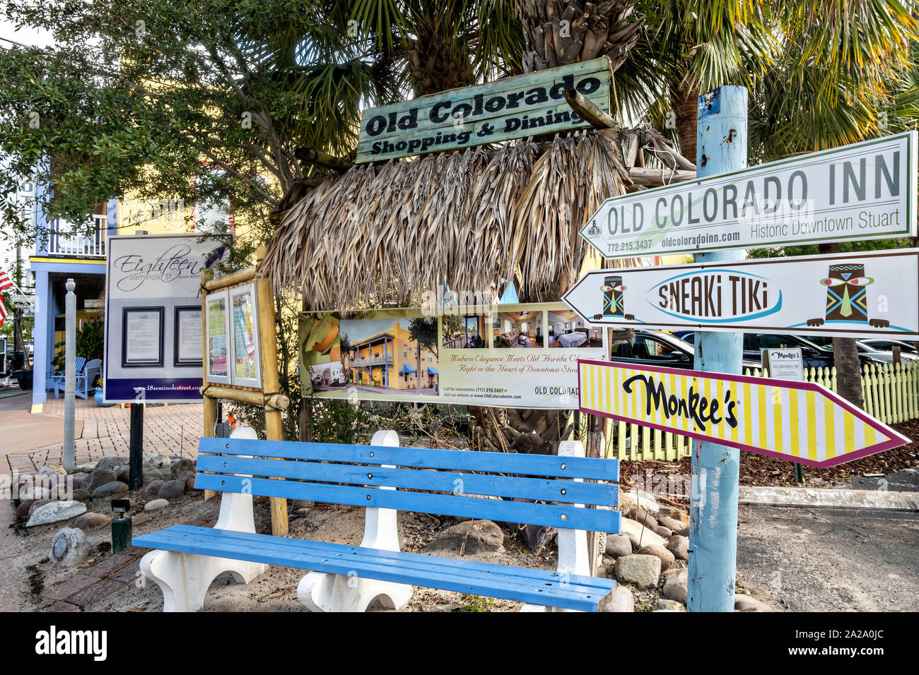 Park bench and signs in the historic downtown of Stuart, Florida. The ...