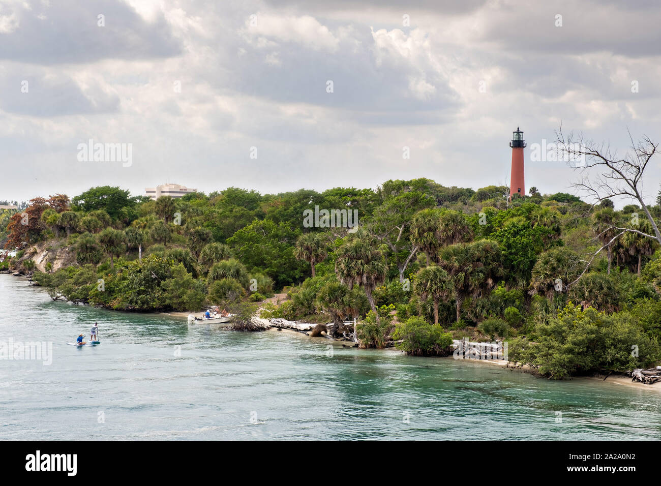Paddle boarders travel along the Indian River past the Jupiter Inlet ...