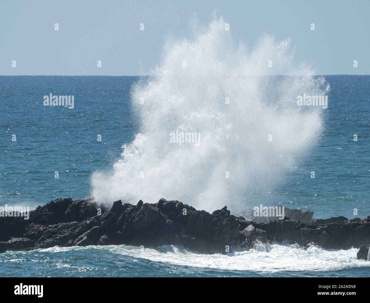 Surf crashing onto rocks Stock Photo - Alamy