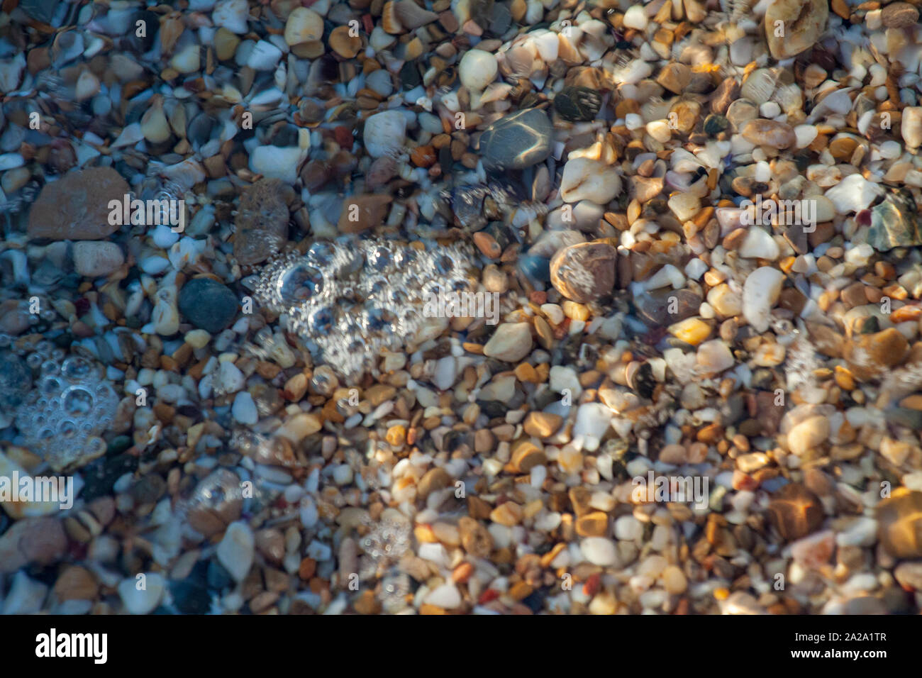 sea pebbles colored granite on the beach background stones. The shore ...