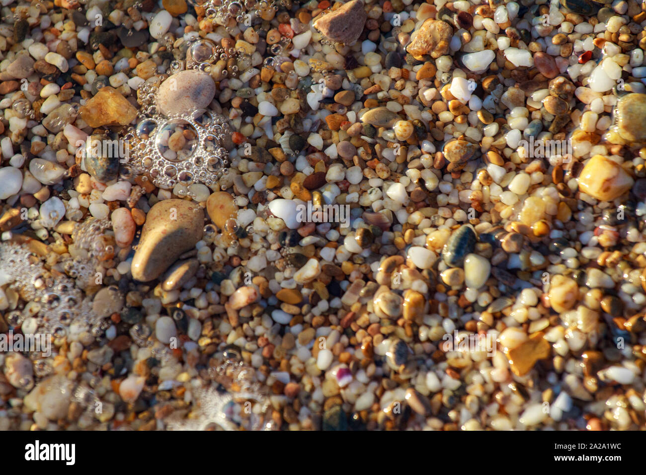 sea pebbles colored granite on the beach background stones. The shore ...