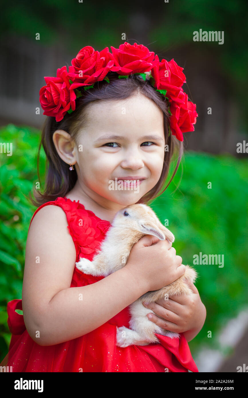 The girl is holding a rabbit. Beautiful little baby with animal ...