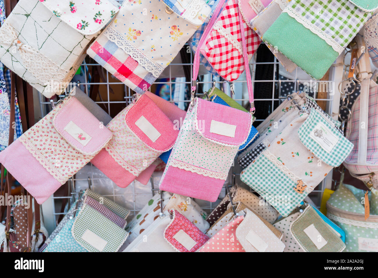 Many small bags for sale at a market on walking street Stock Photo - Alamy