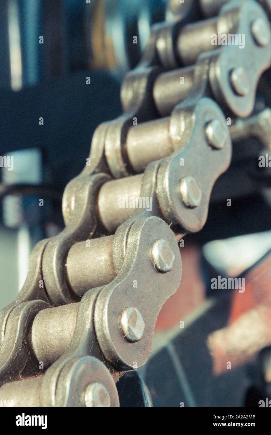 Metal chain in agricultural or industrial machinery. Technology concept ...
