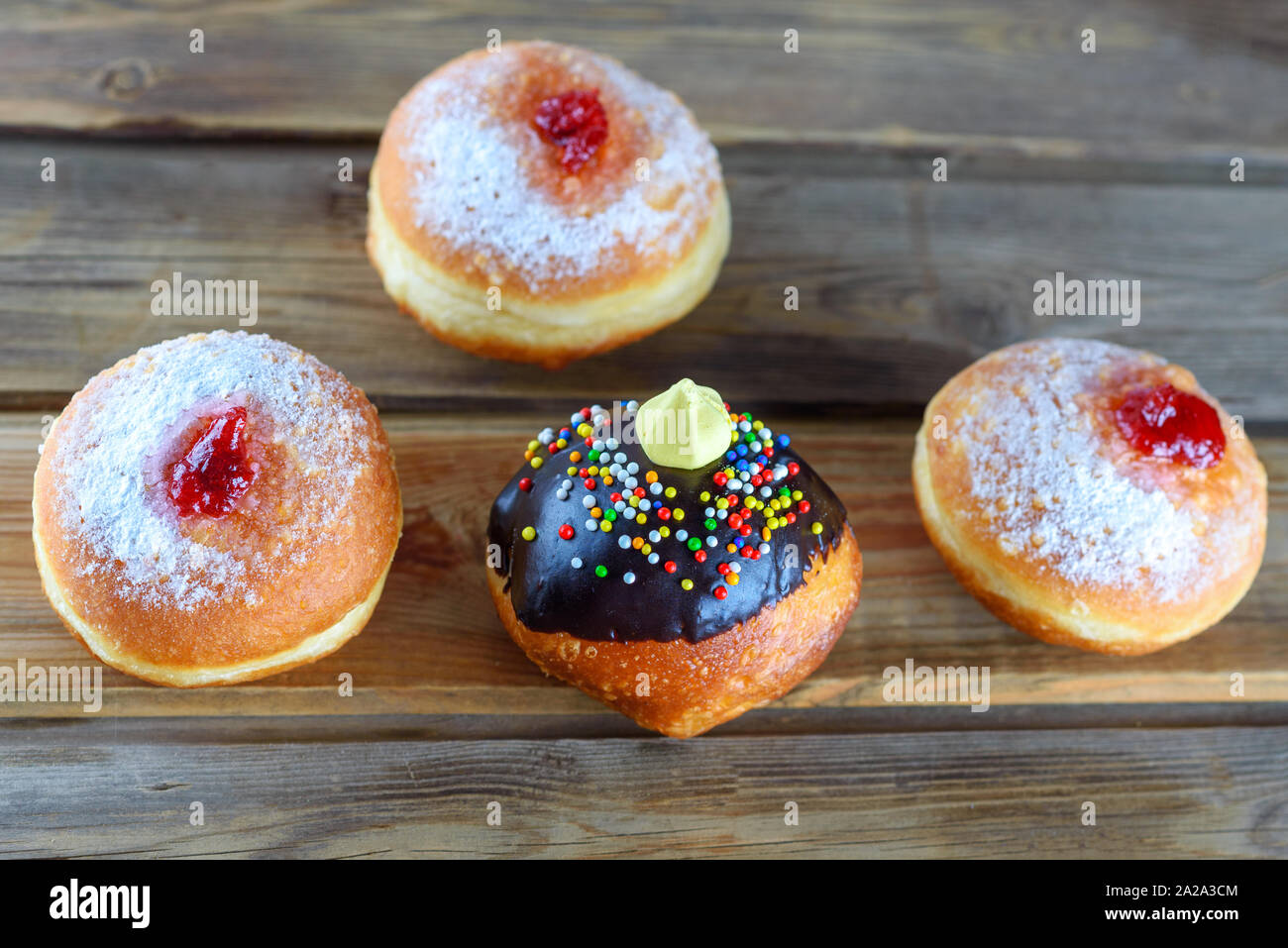 Round jelly doughnut sufganiyot and chocolate sufganiyah for Hanukkah ...