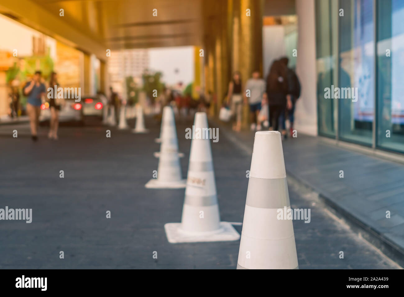 The white traffic cones are set up as a pedestrian safety zone in front ...