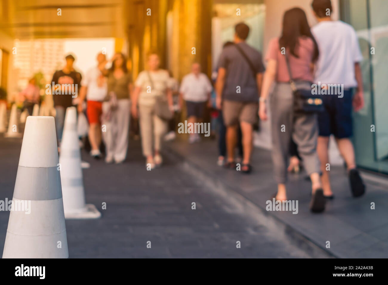 The white traffic cones are set up as a pedestrian safety zone in front ...