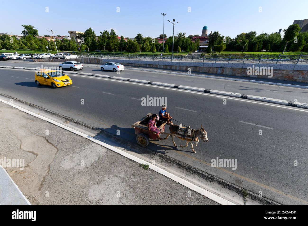 Samarkand, Uzbekistan - July 10, 2019: Children riding a donkey cart on ...