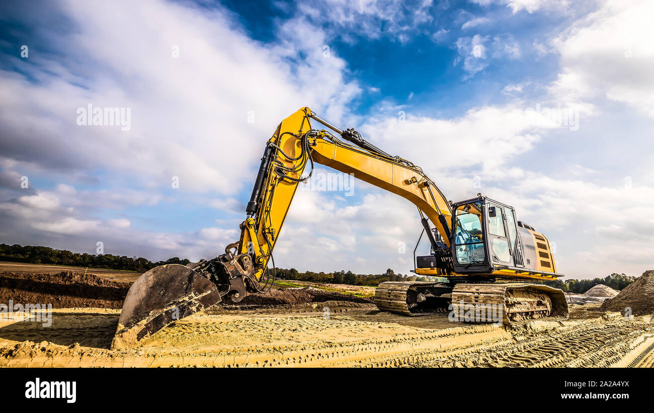 Big excavator in construction site Stock Photo - Alamy