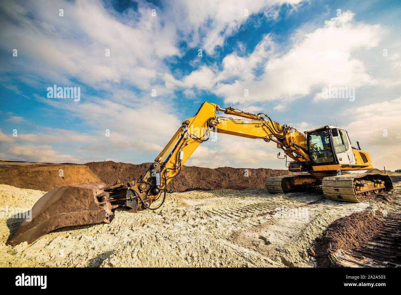 Big excavator in construction site Stock Photo - Alamy