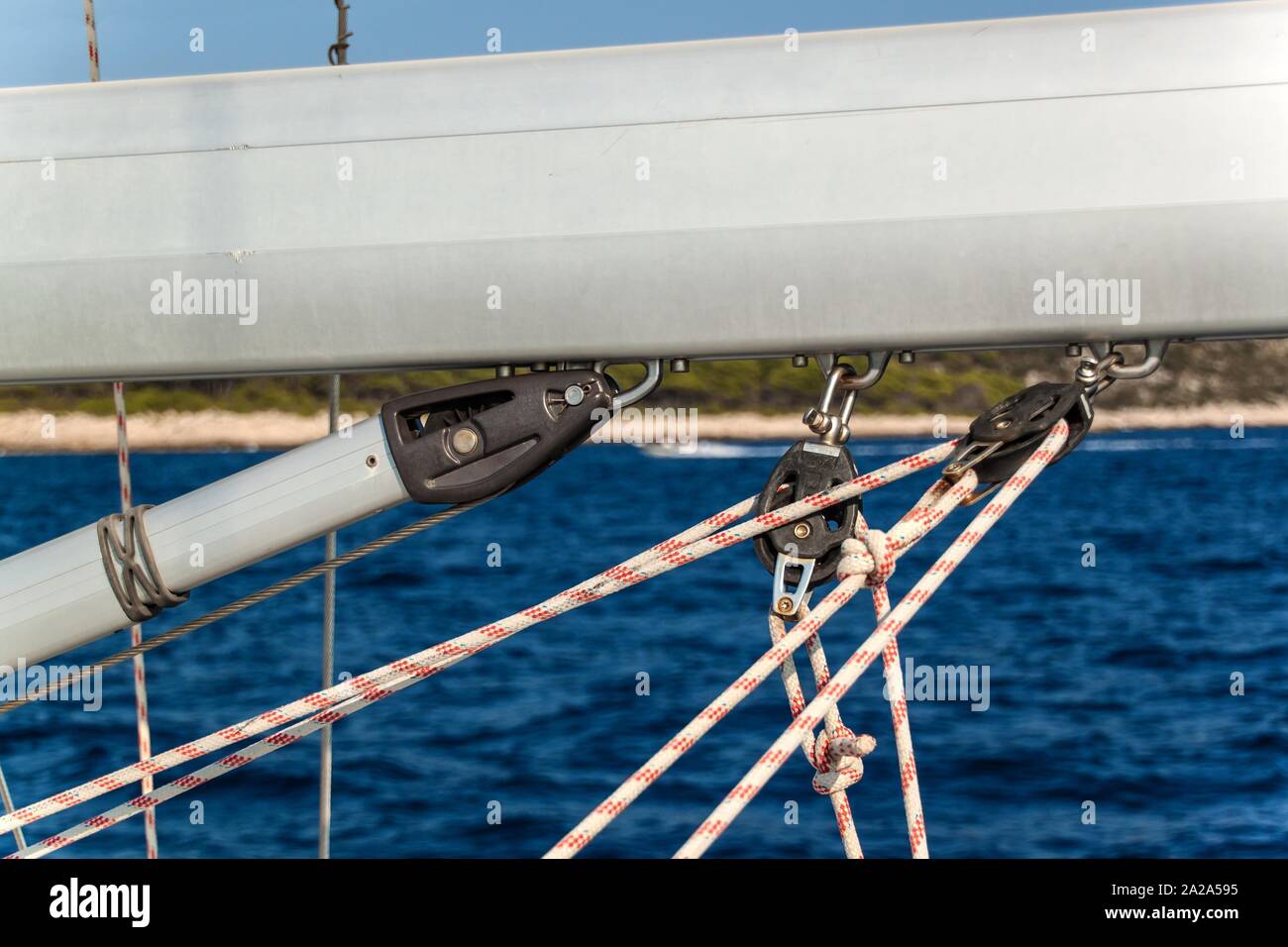 Close-up view of sailboat ropes. Pulleys and ropes on the mast ...