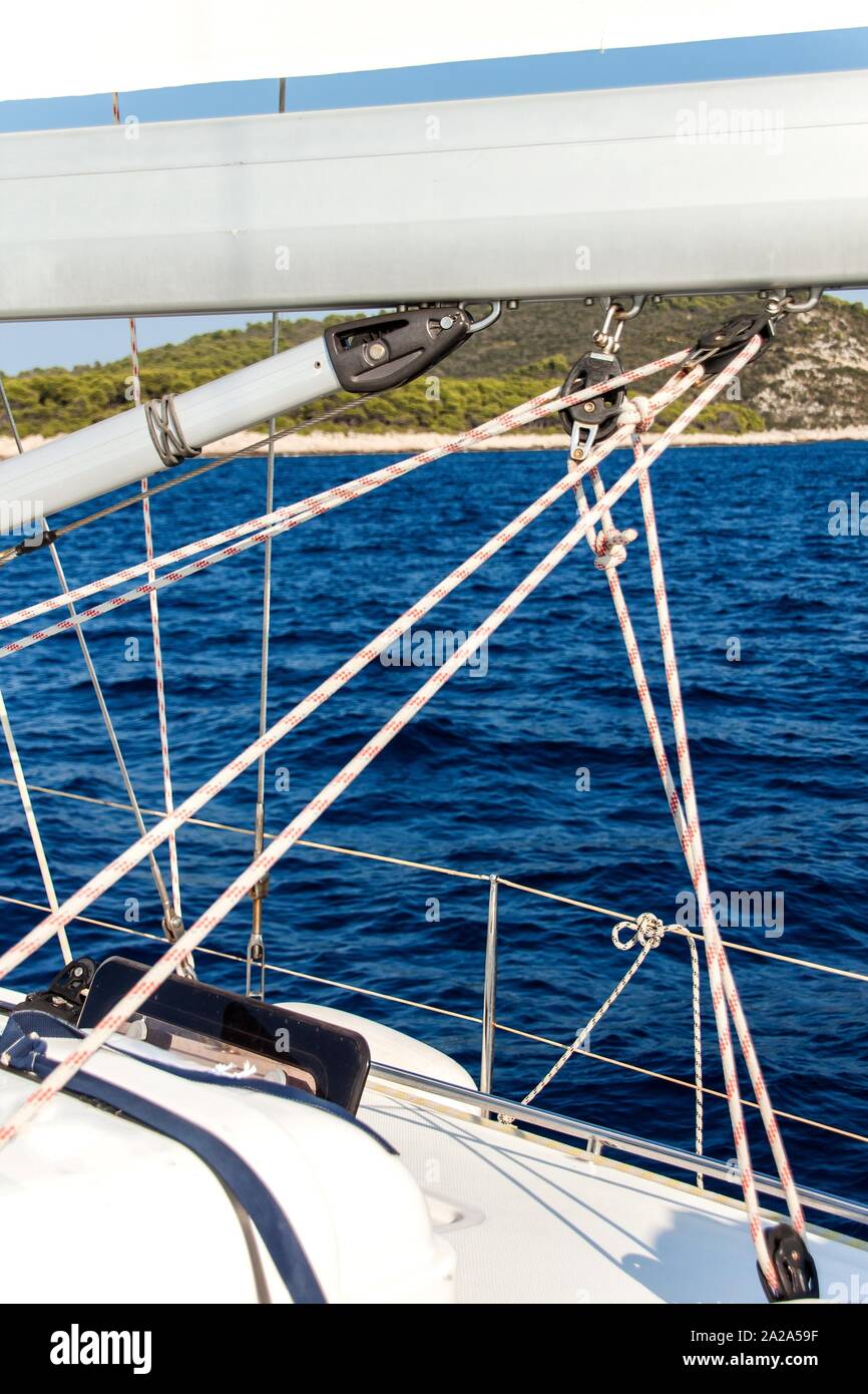 Close-up view of sailboat ropes. Pulleys and ropes on the mast ...