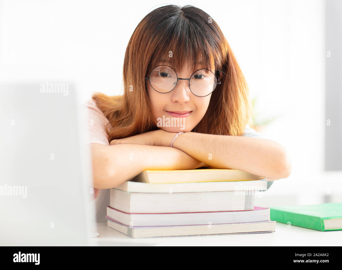 Teenage girl studying book at home Stock Photo - Alamy