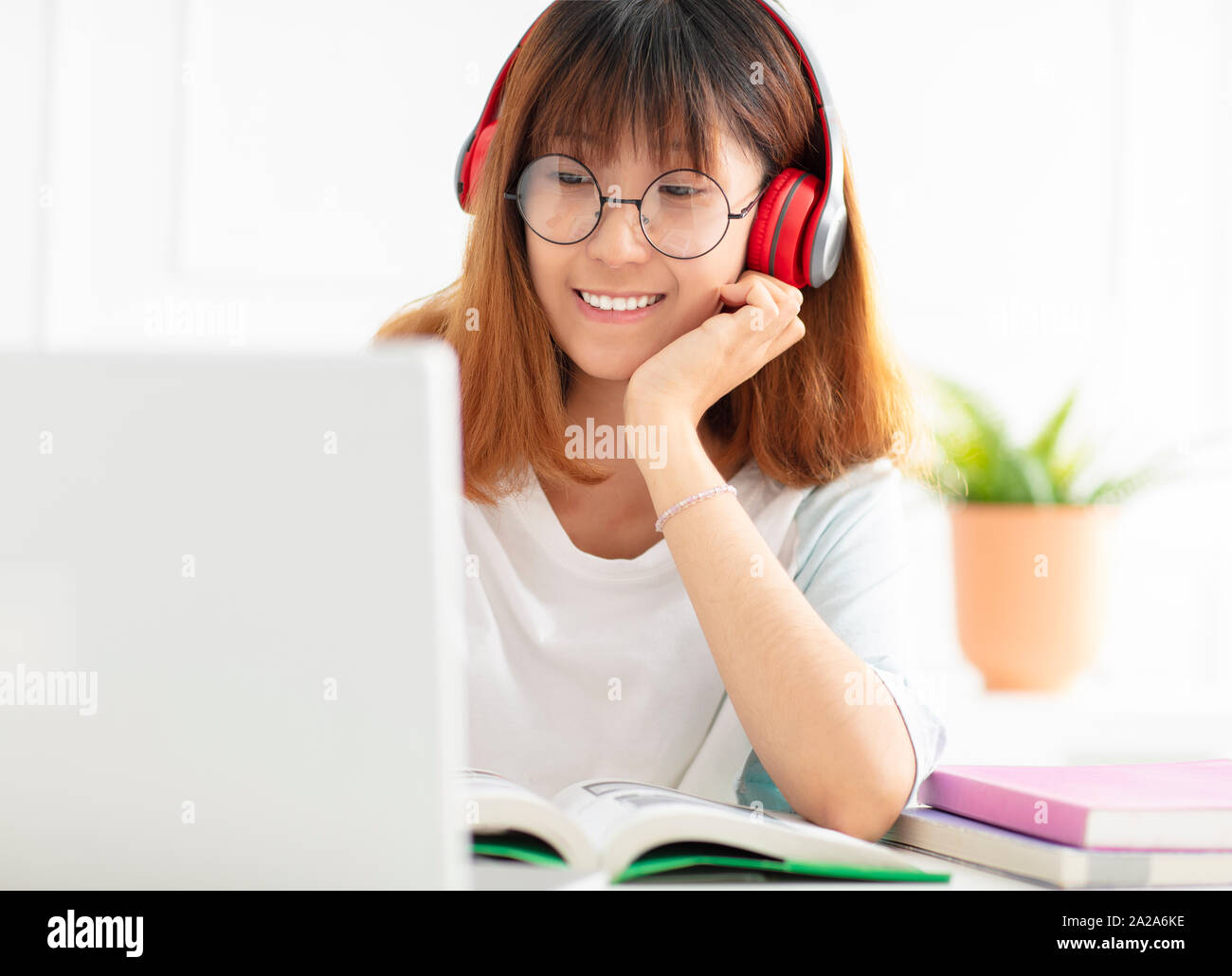 Teenage girl studying book at home Stock Photo - Alamy
