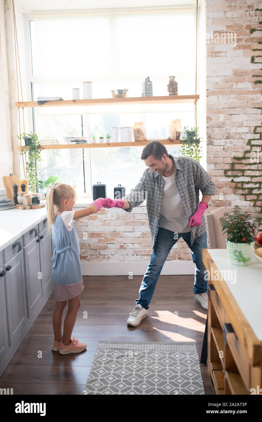 Father and daughter having much fun while cleaning kitchen Stock Photo ...