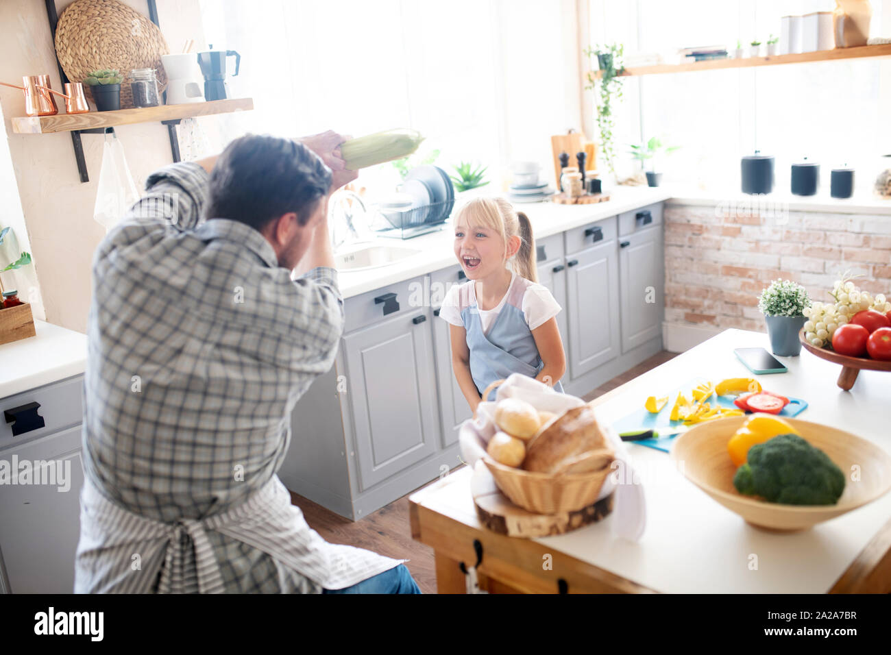 Father and daughter laughing and joking while cooking Stock Photo - Alamy