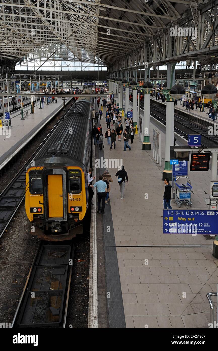 Passengers getting on and off a Class 156 Super Sprinter train at ...