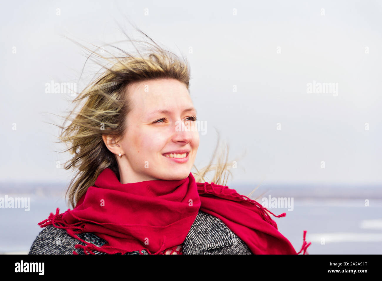 A strong wind is blowing hair have happiest women dressed in gray ...