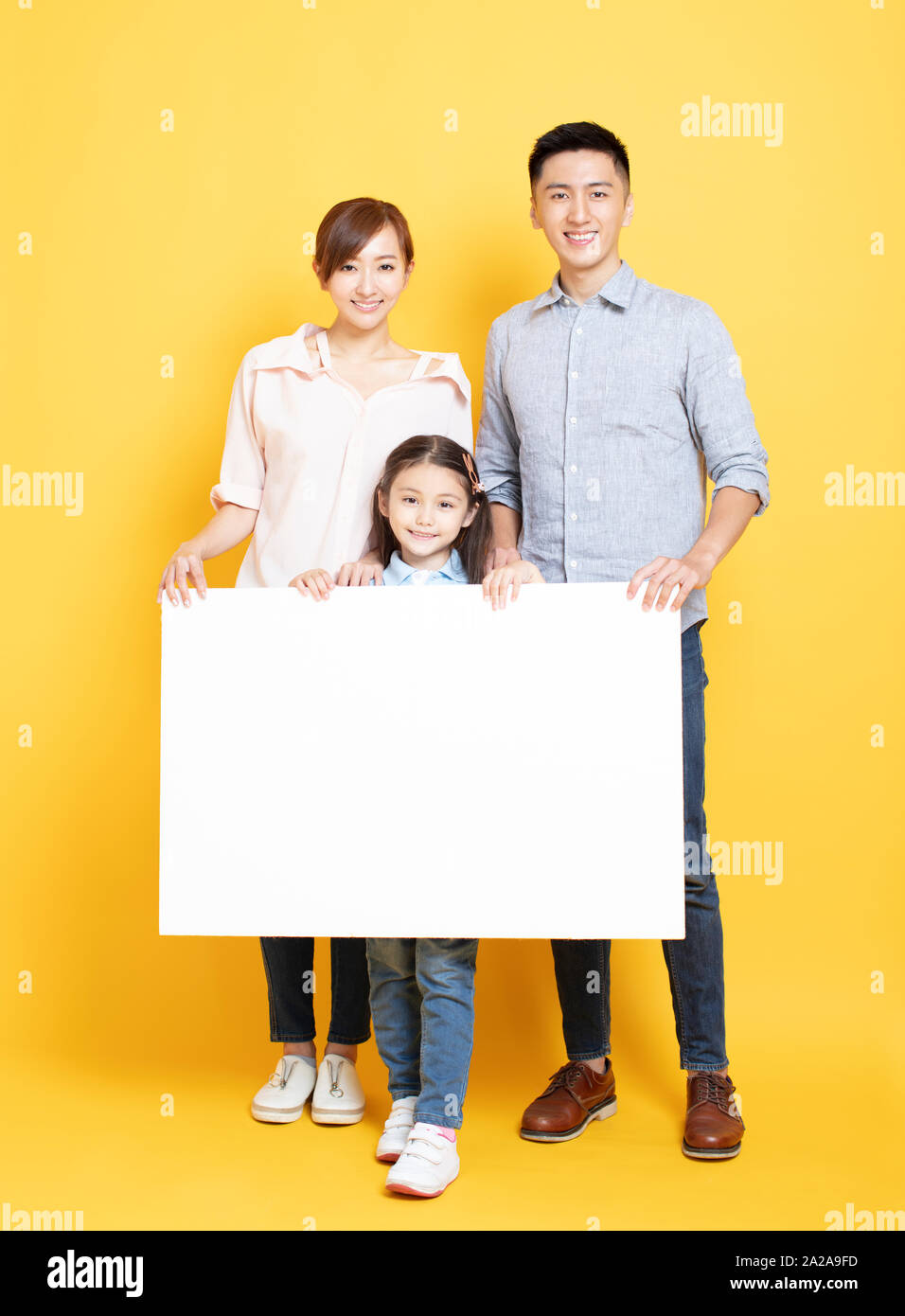 happy family with blank advertising banner Stock Photo - Alamy