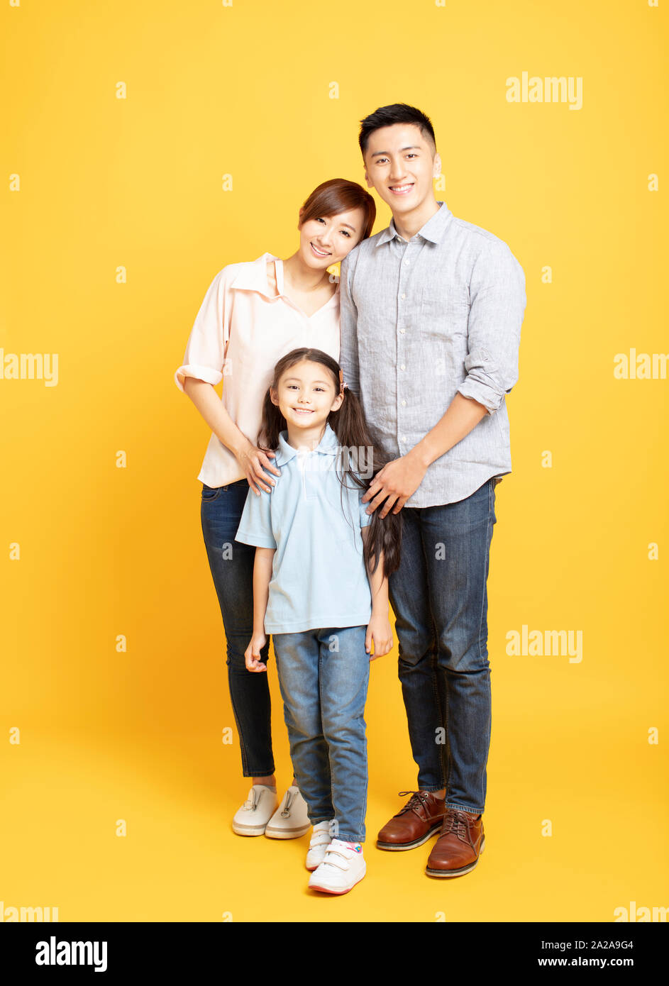 portrait of happy family standing together isolated Stock Photo - Alamy